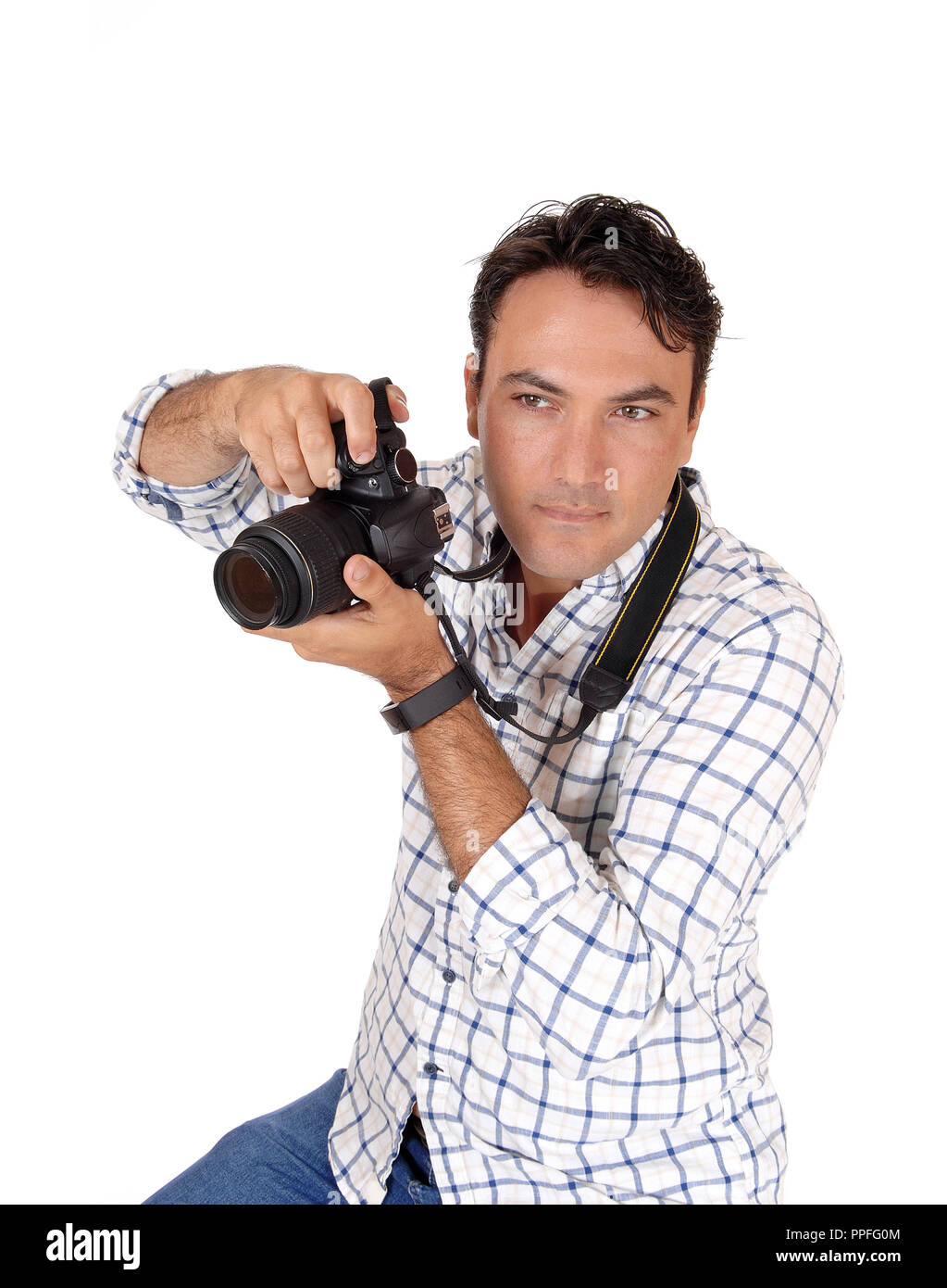 A close-up image of a handsome man holding his camera ready of a shoot ...