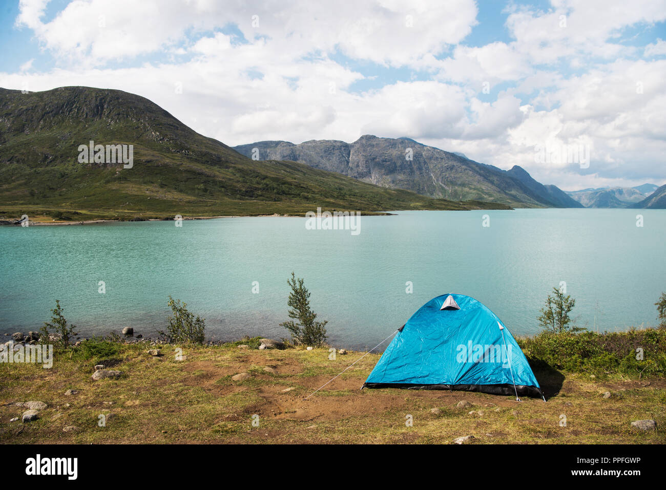 blue tent on Besseggen ridge over Gjende lake in Jotunheimen National ...