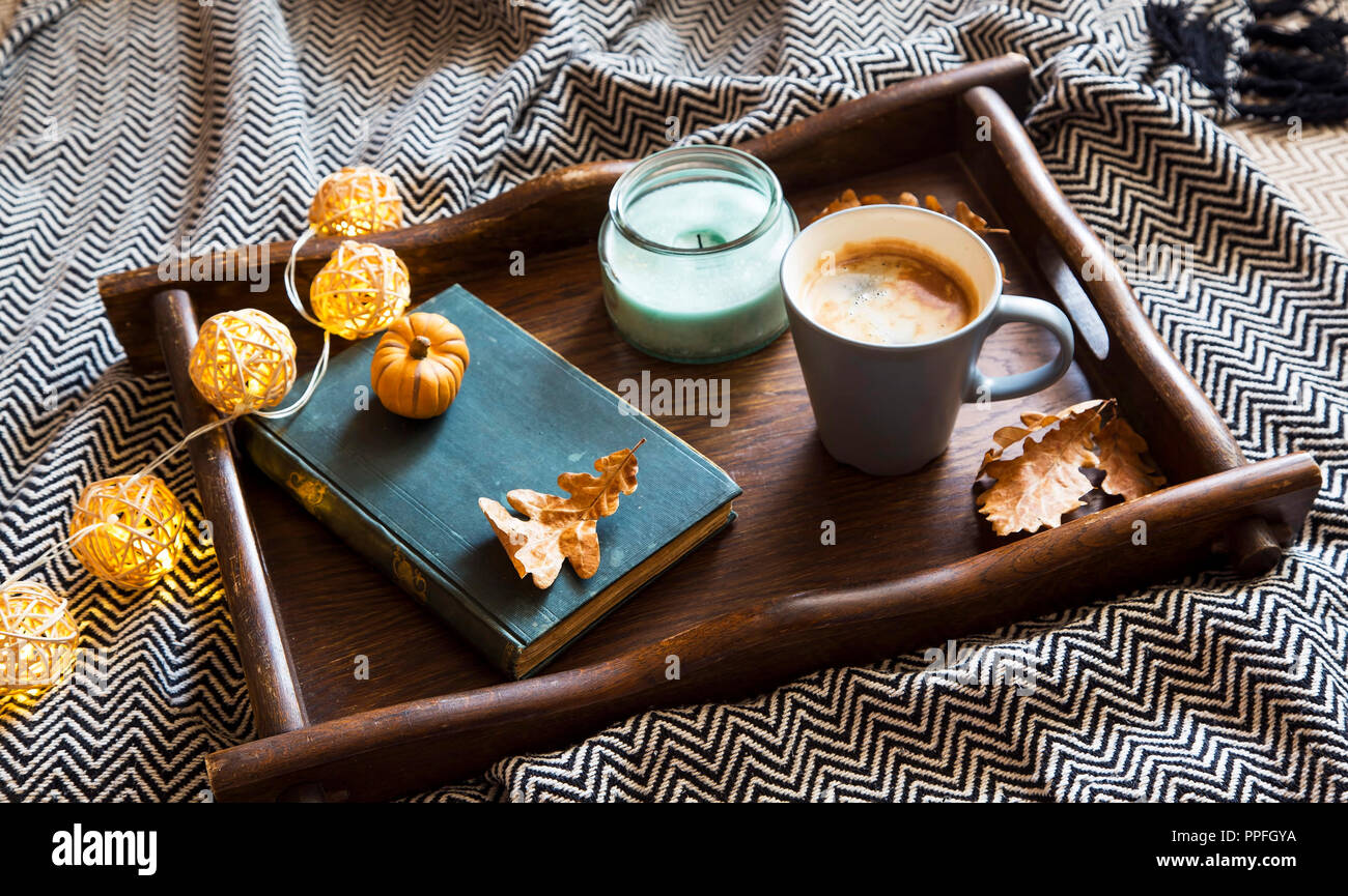 Autumn cozy setting with wooden tray on a blanket, with cup of coffee ...