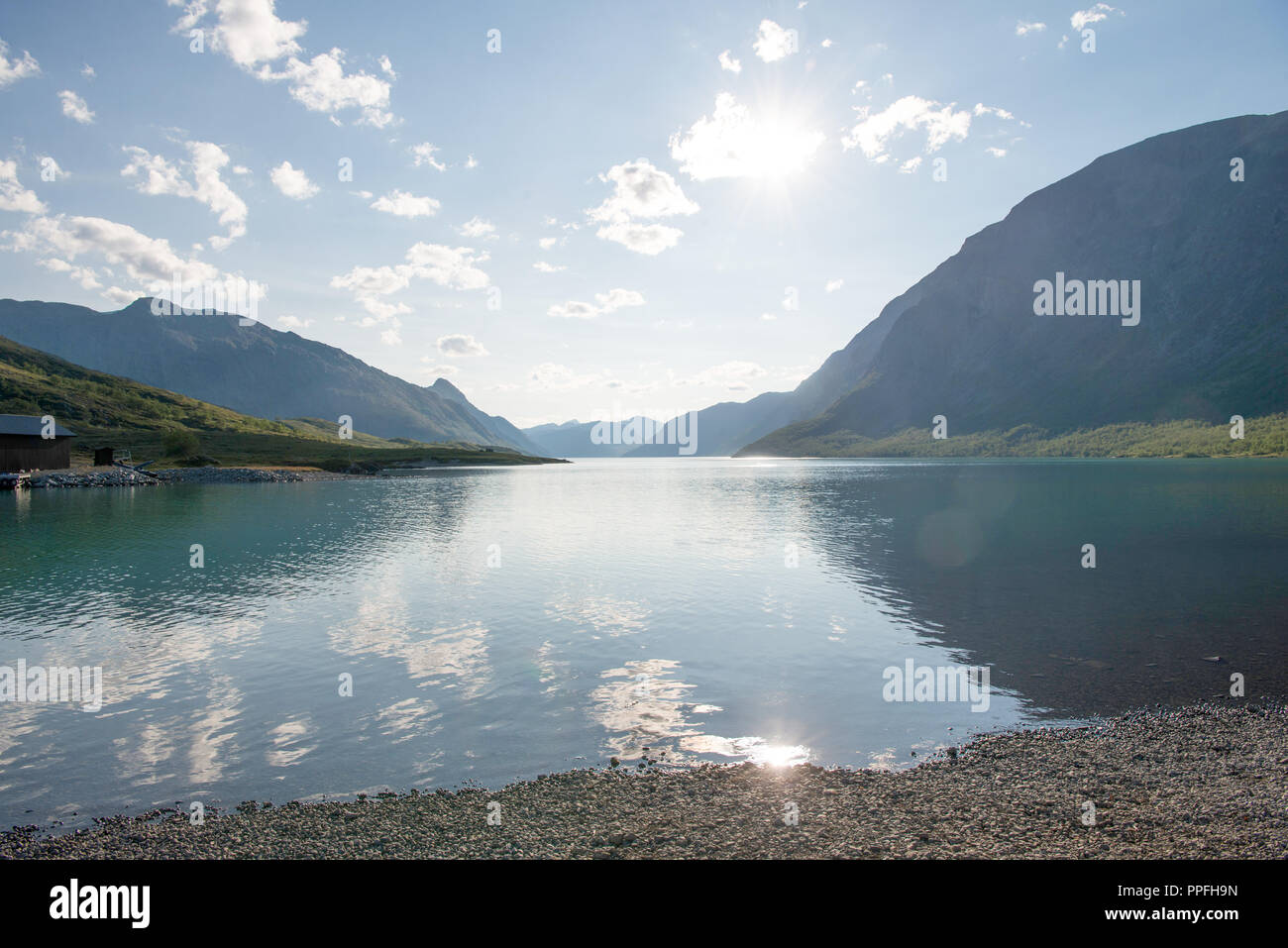 beautiful landscape with majestic mountains reflected in calm water of ...