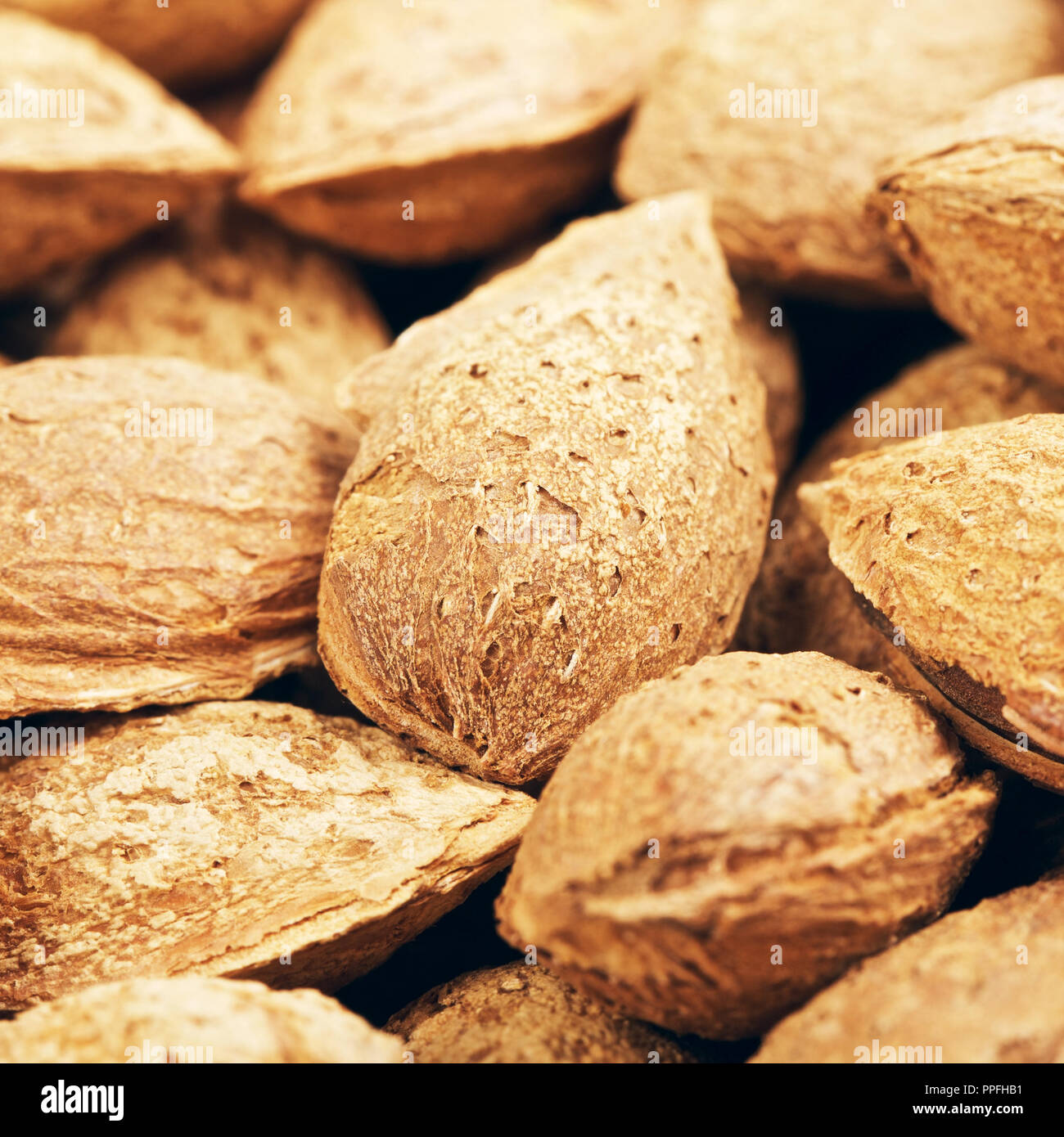 fresh raw unpeeled almonds nuts, food background Stock Photo - Alamy