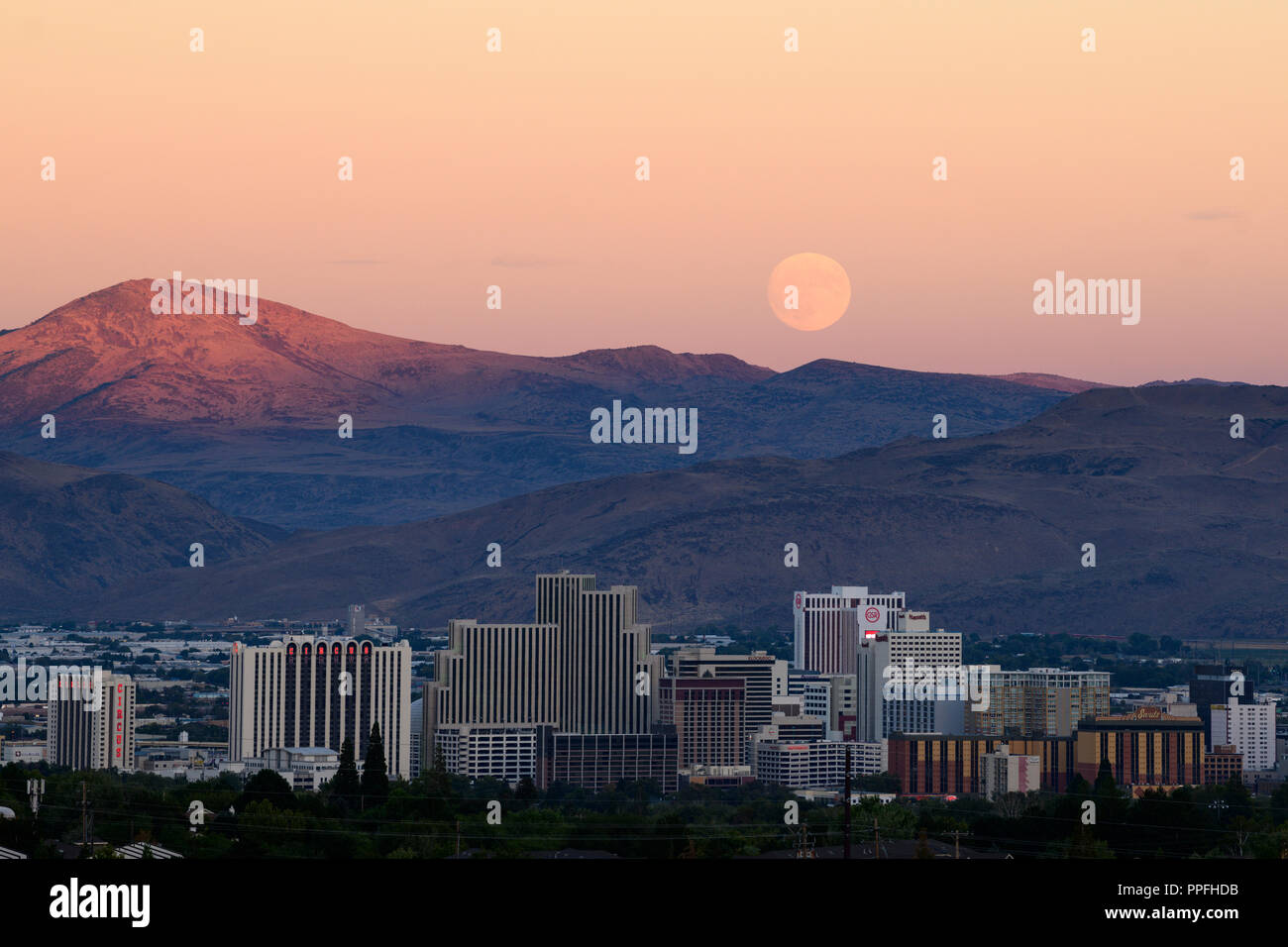 Full Harvest Moon rise over downtown Reno skyline just after the fall ...