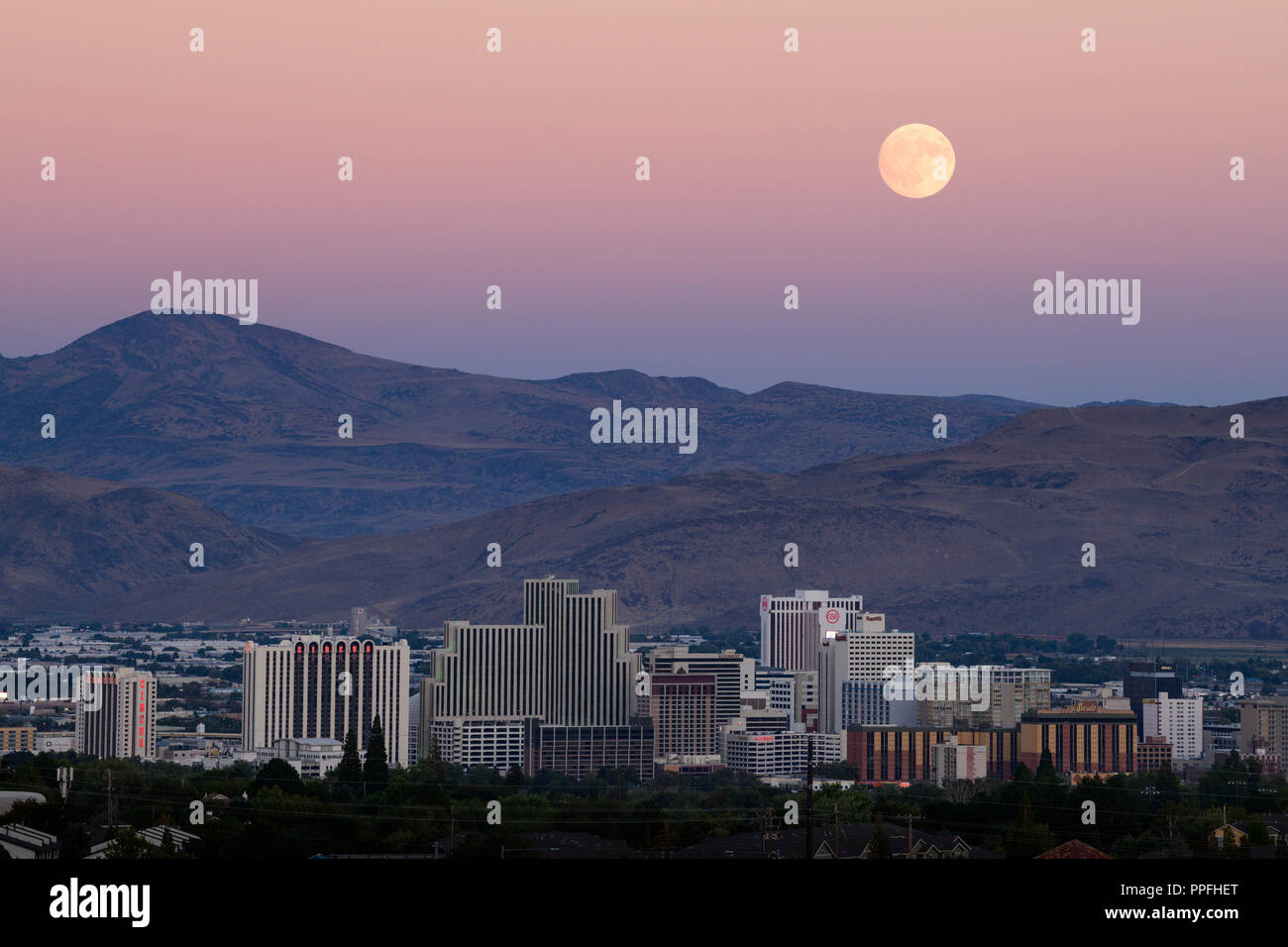 Full Harvest Moon rise over downtown Reno skyline just after the fall ...