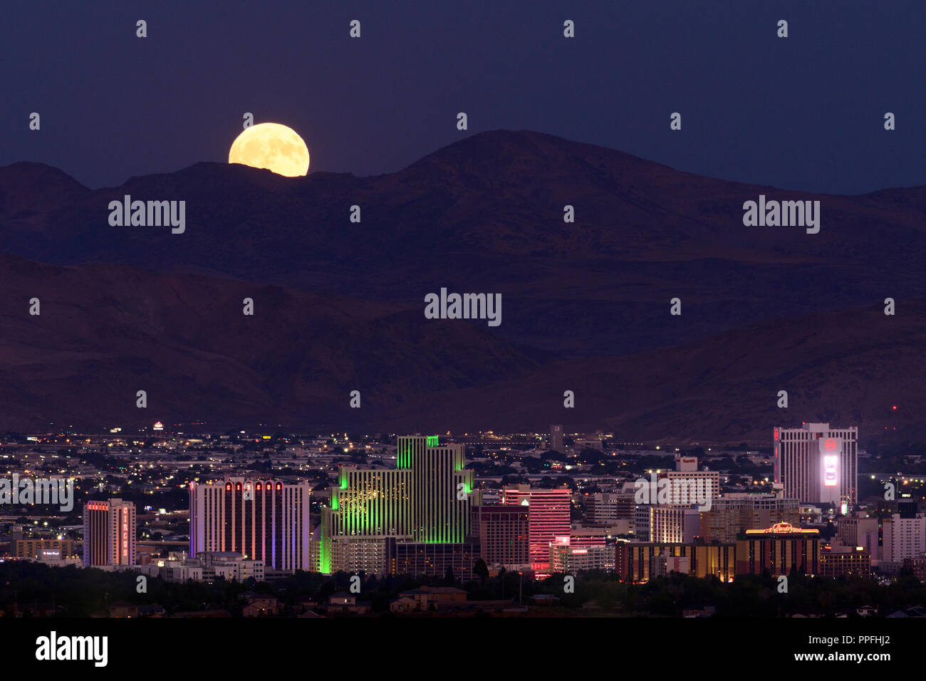 Full Harvest Moon rise over downtown Reno skyline just after the fall ...