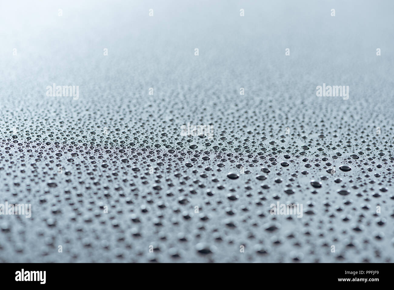 close up view of water drops on grey surface as background Stock Photo ...