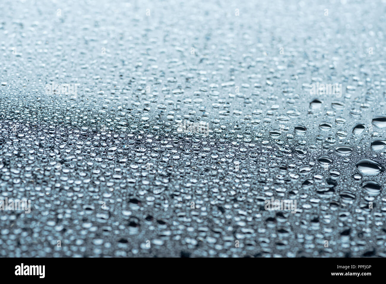 close up view of water drops on grey surface as background Stock Photo ...