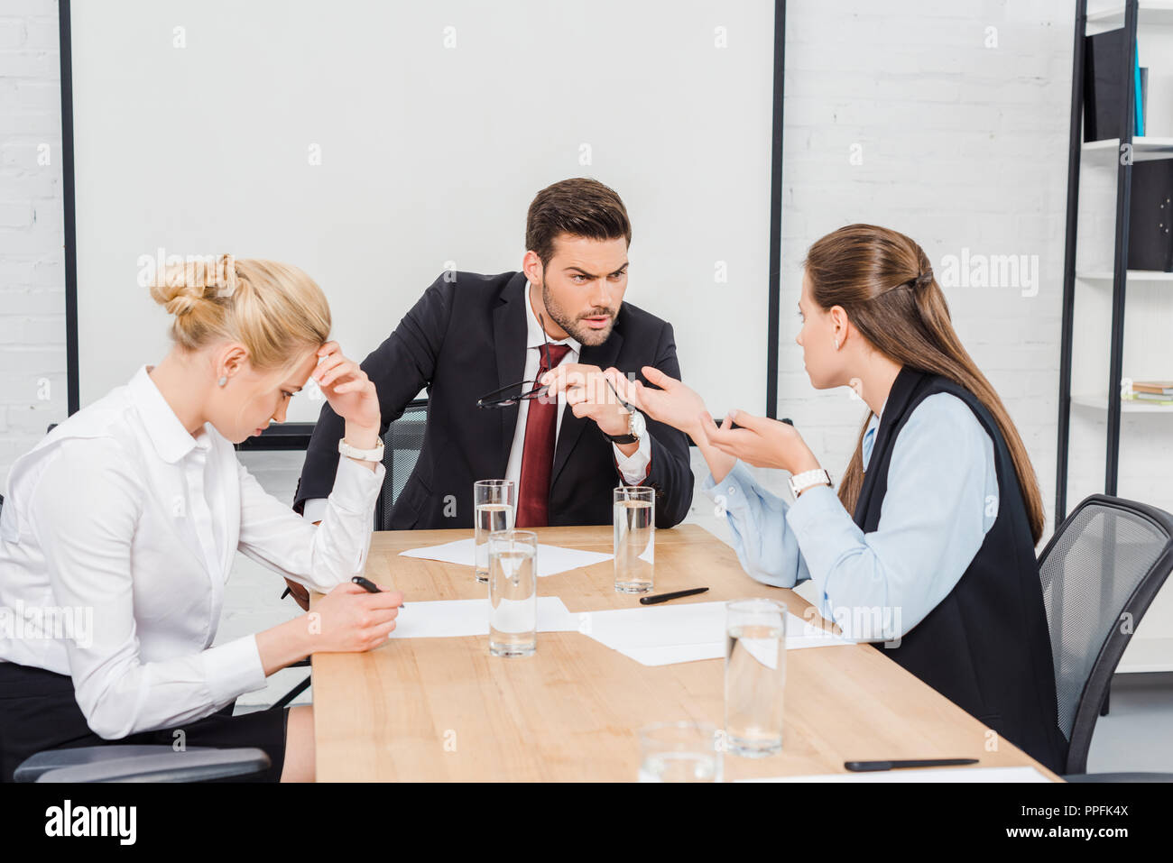angry boss talking with his female colleagues at modern office Stock ...