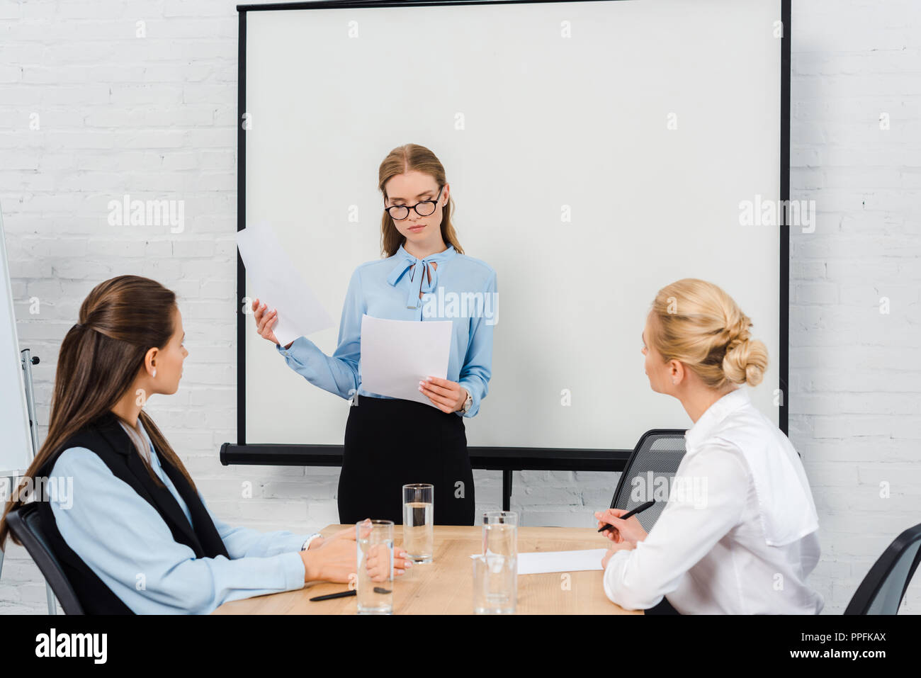 beautiful young businesswomen having conversation with boss at modern ...