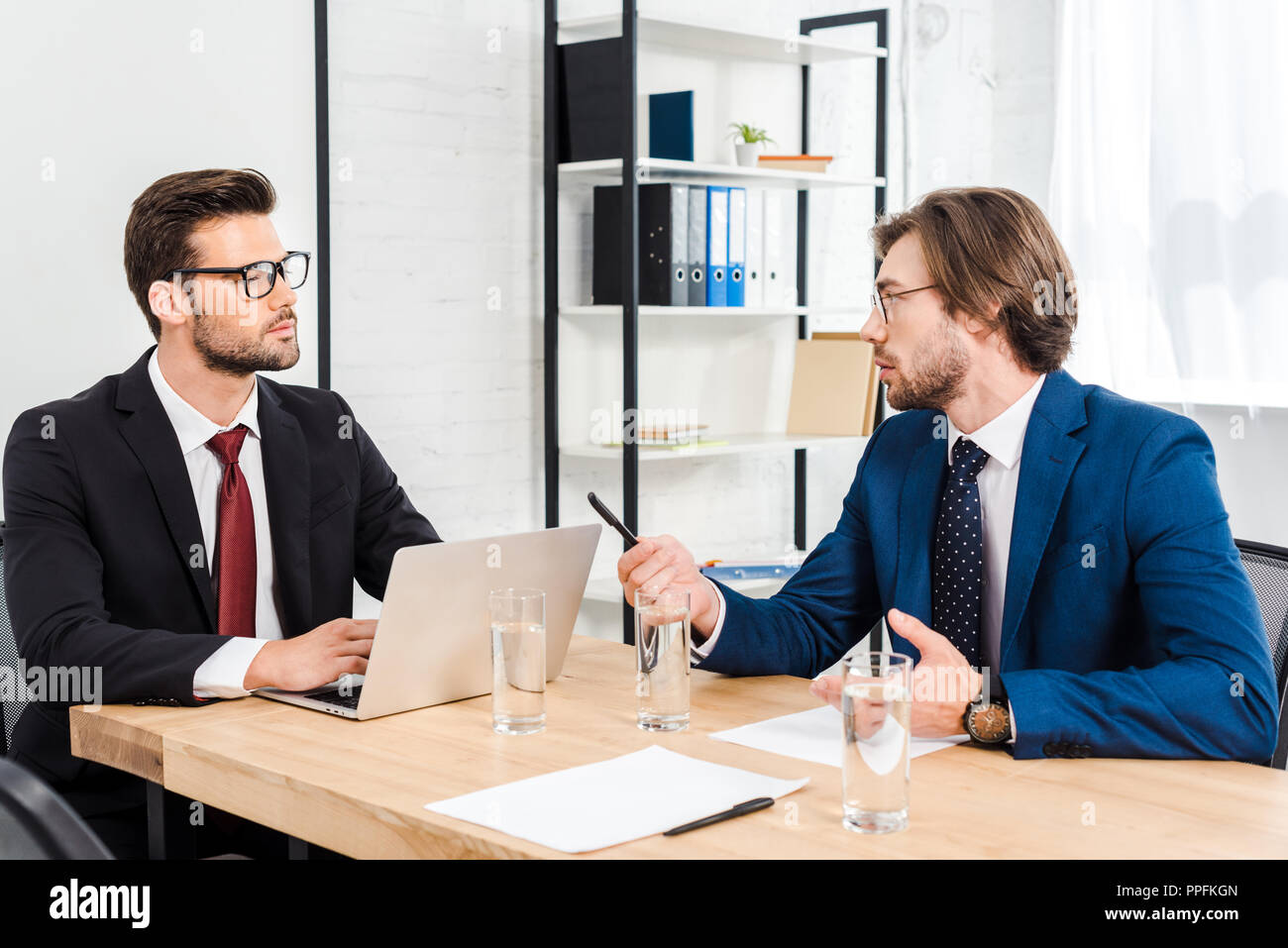 successful young businessmen having conversation at modern office Stock ...
