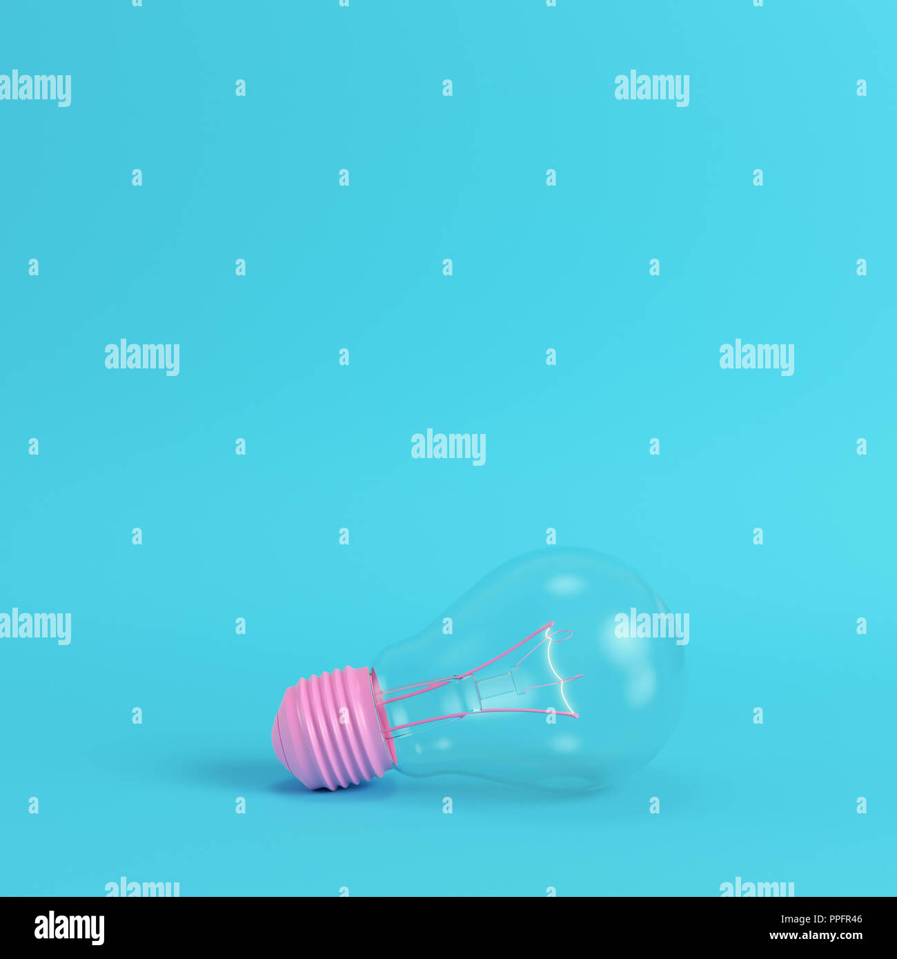 Pink light bulb with glowing spiral on bright blue background in pastel ...