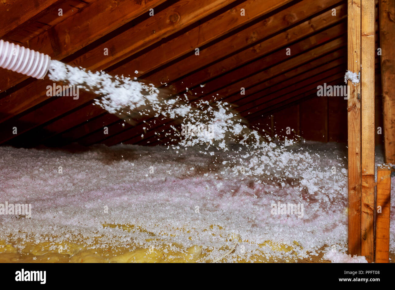 Worker Spraying mineral rock wool of thermal insulation layer under the ...
