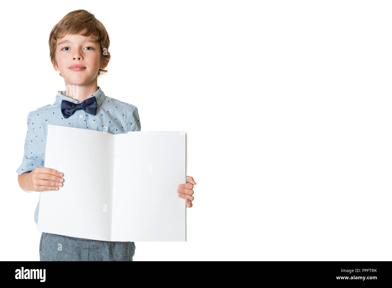 young boy holding blank notebook, isolated on white background with ...