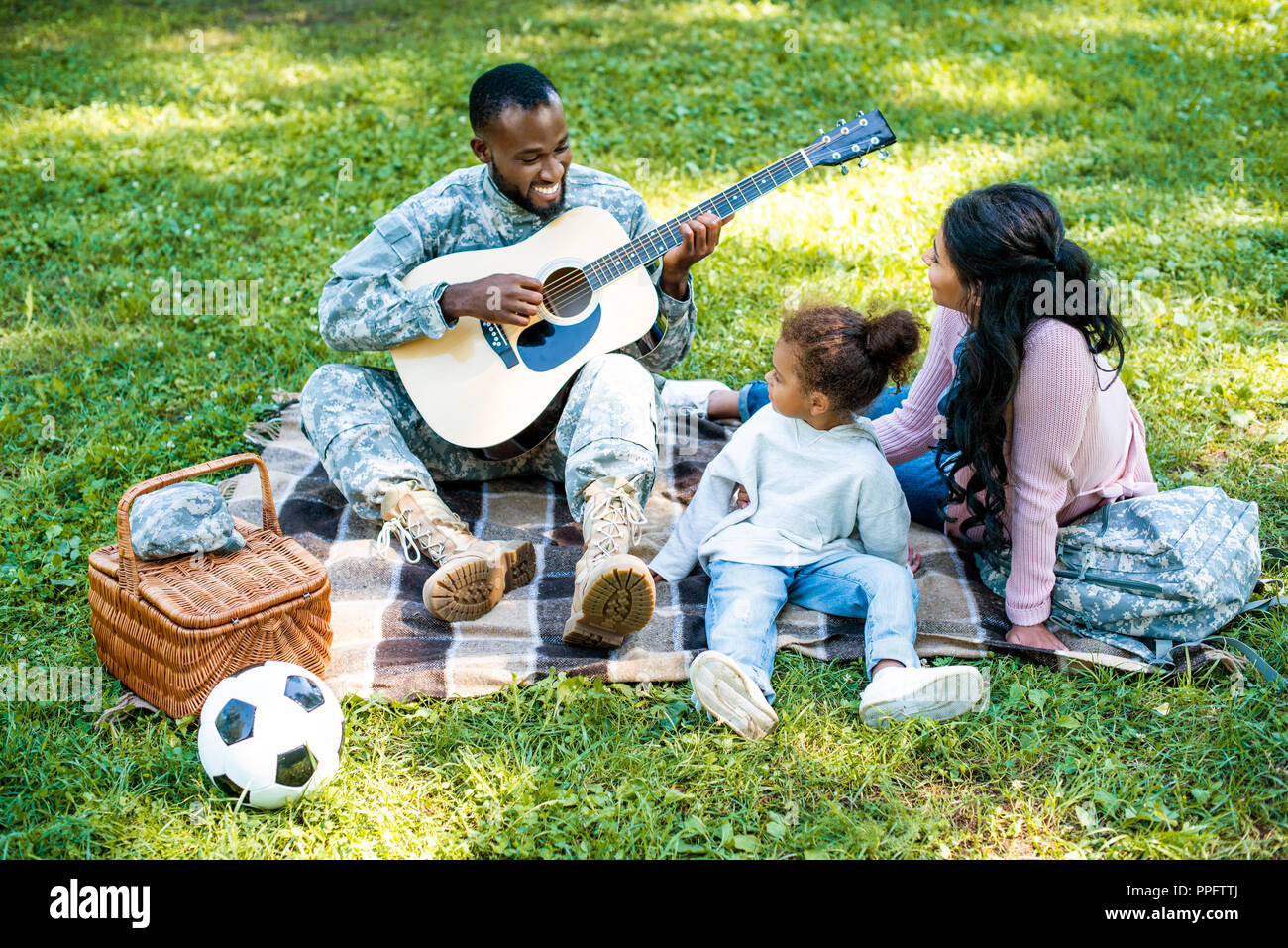 Soldier playing the guitar hi-res stock photography and images - Alamy