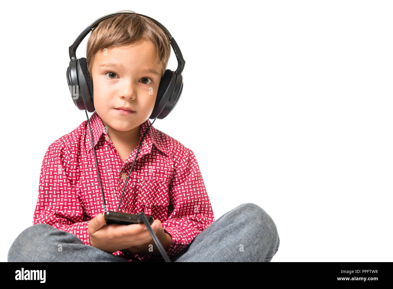 young adorable boy with headphones listening music, isolated on white ...
