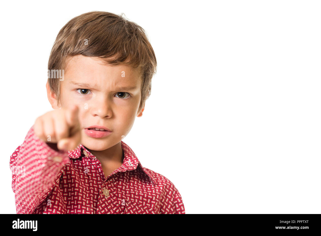 young adorable boy pointing with finger towards you, focus on face ...