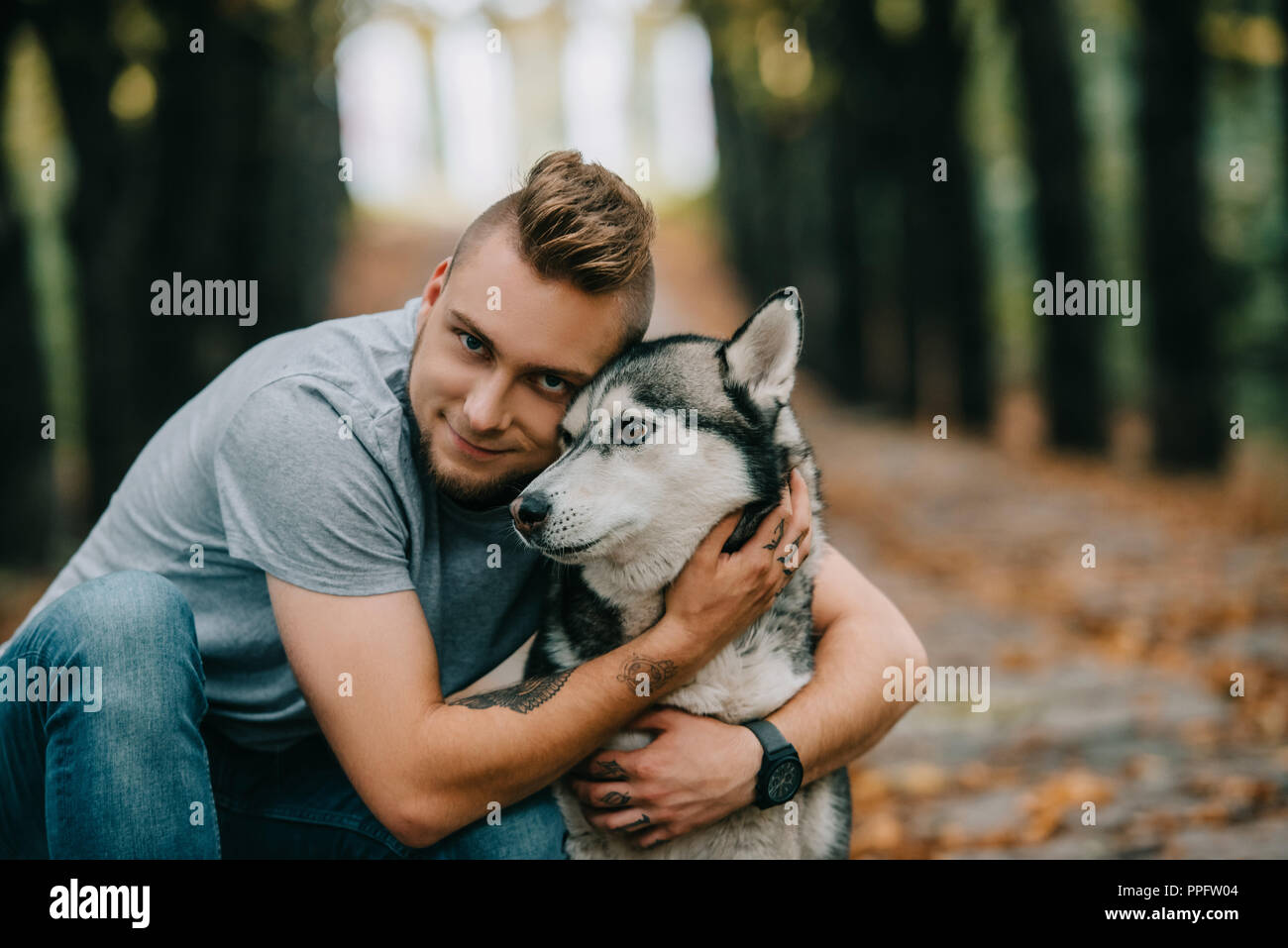 Man hugging siberian husky hi-res stock photography and images - Alamy