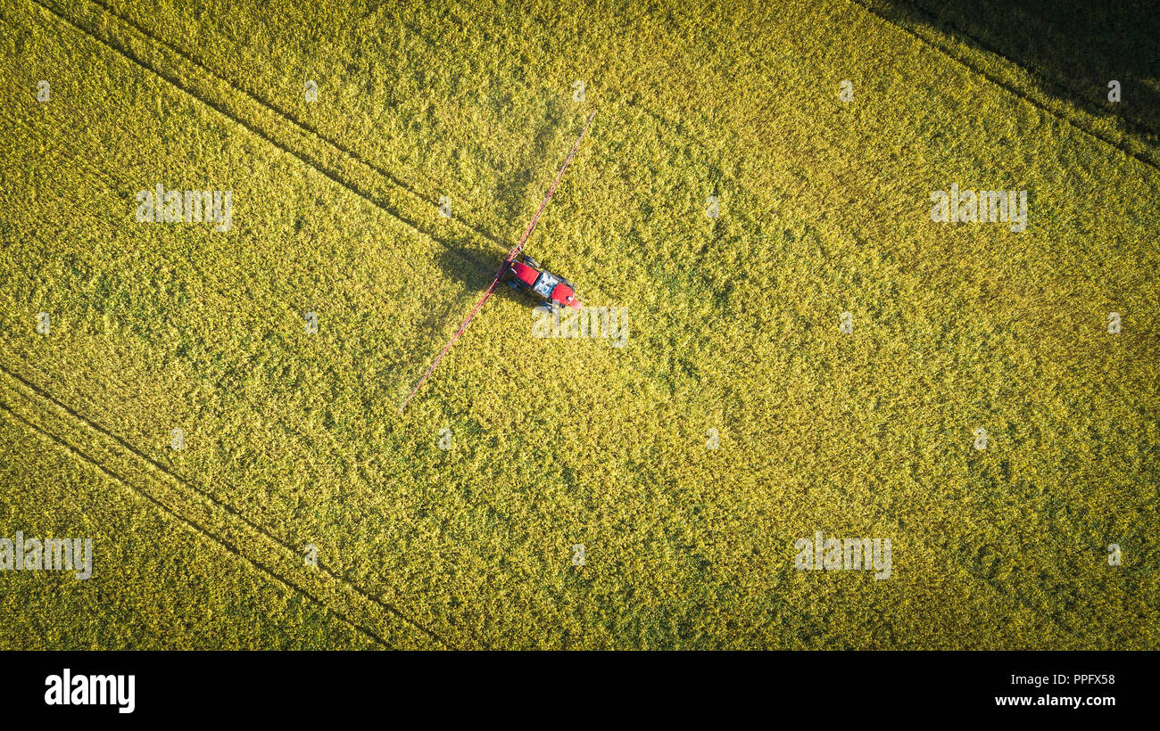 Agricultural machinery in the field. Tractor with a sprayer. Aerial ...
