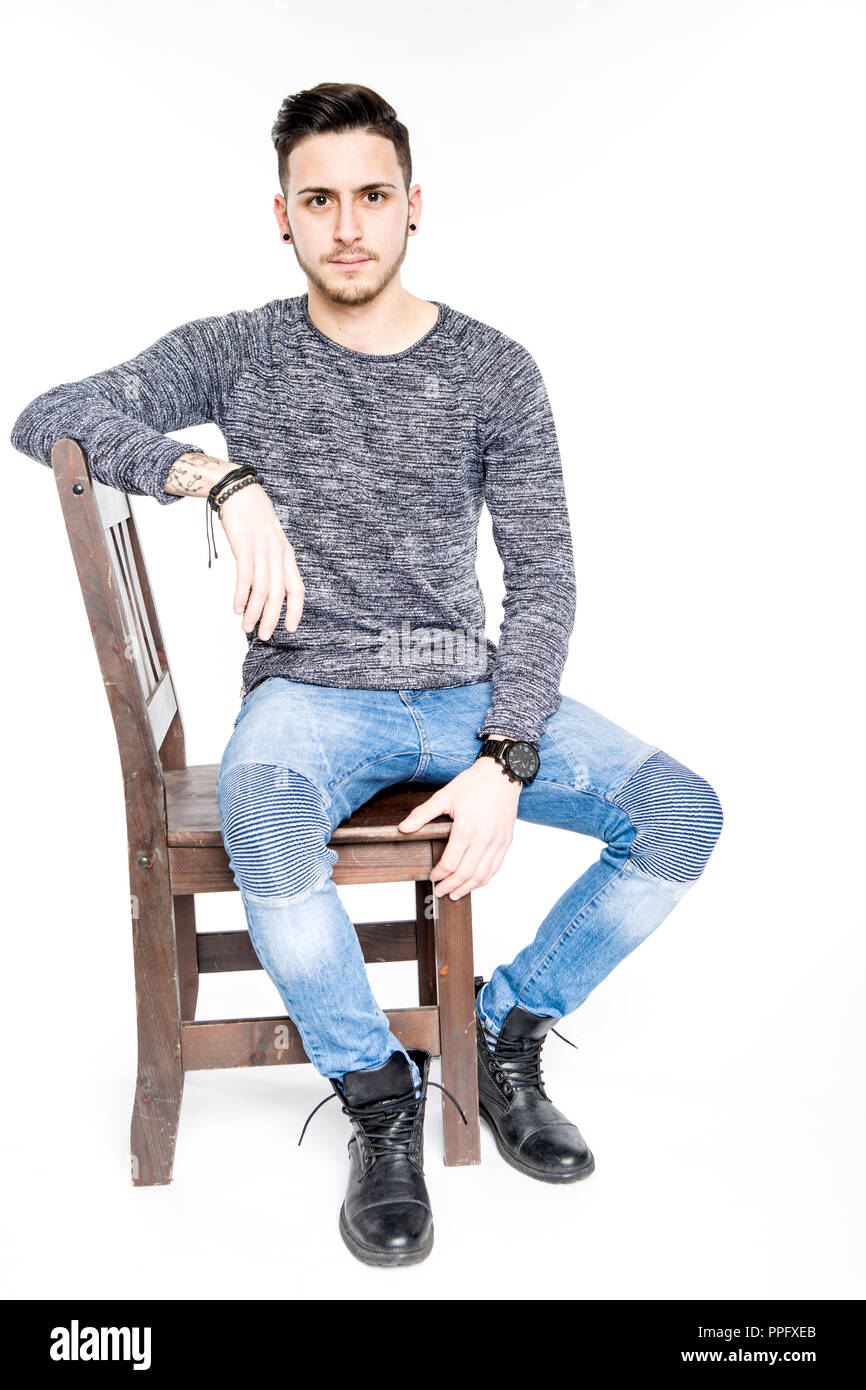 man in studio on chair look straight into camera Stock Photo - Alamy