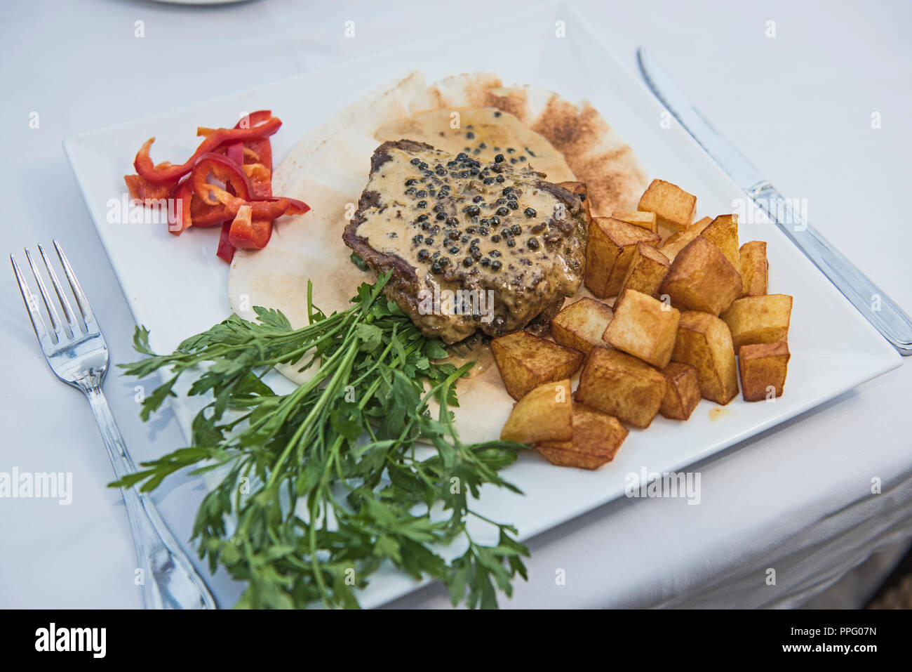 Closeup detail of beef fillet steak in pepper sauce at luxury ...