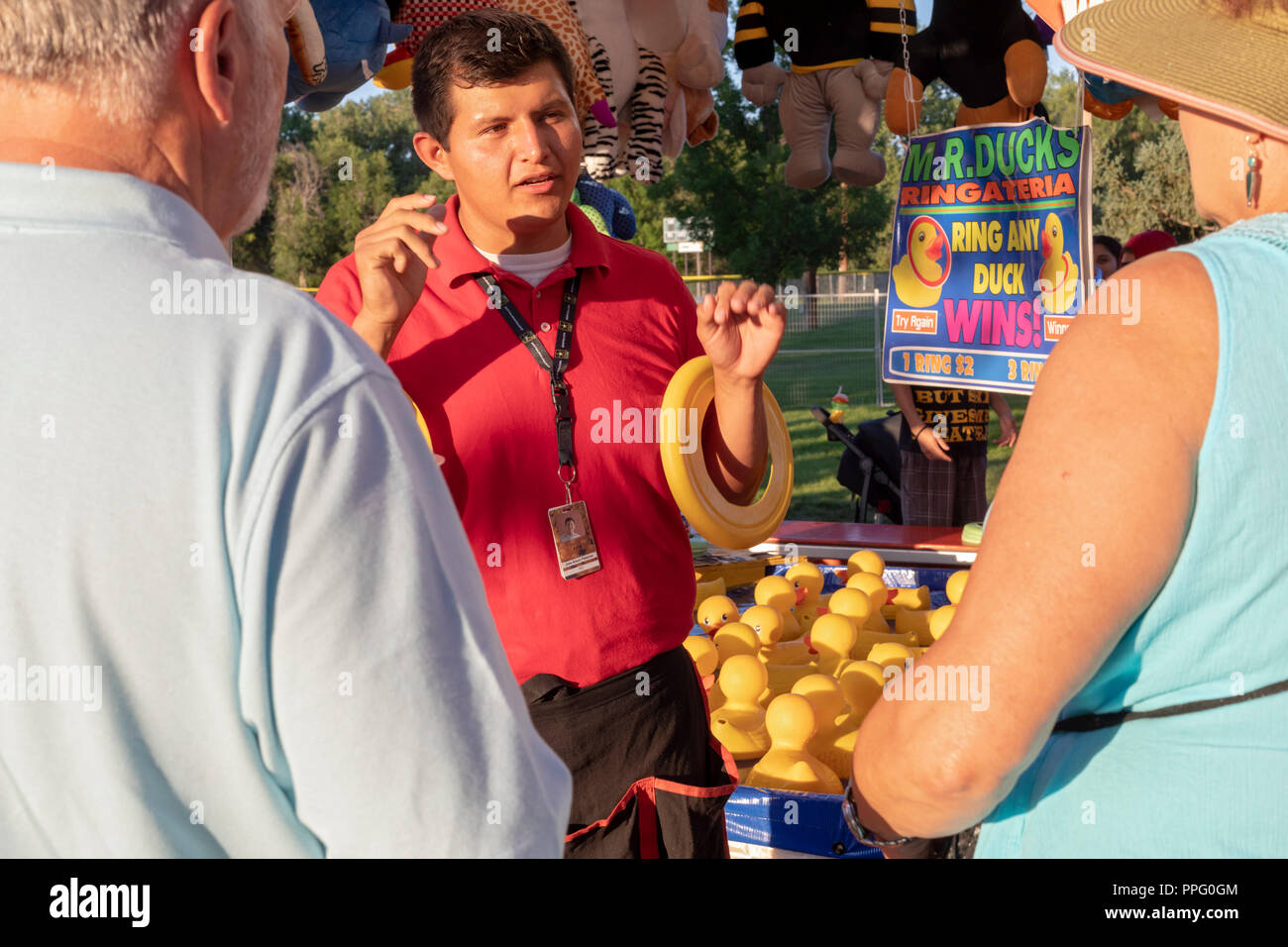 Wheat Ridge, Colorado - A worker explains a game at the annual ...