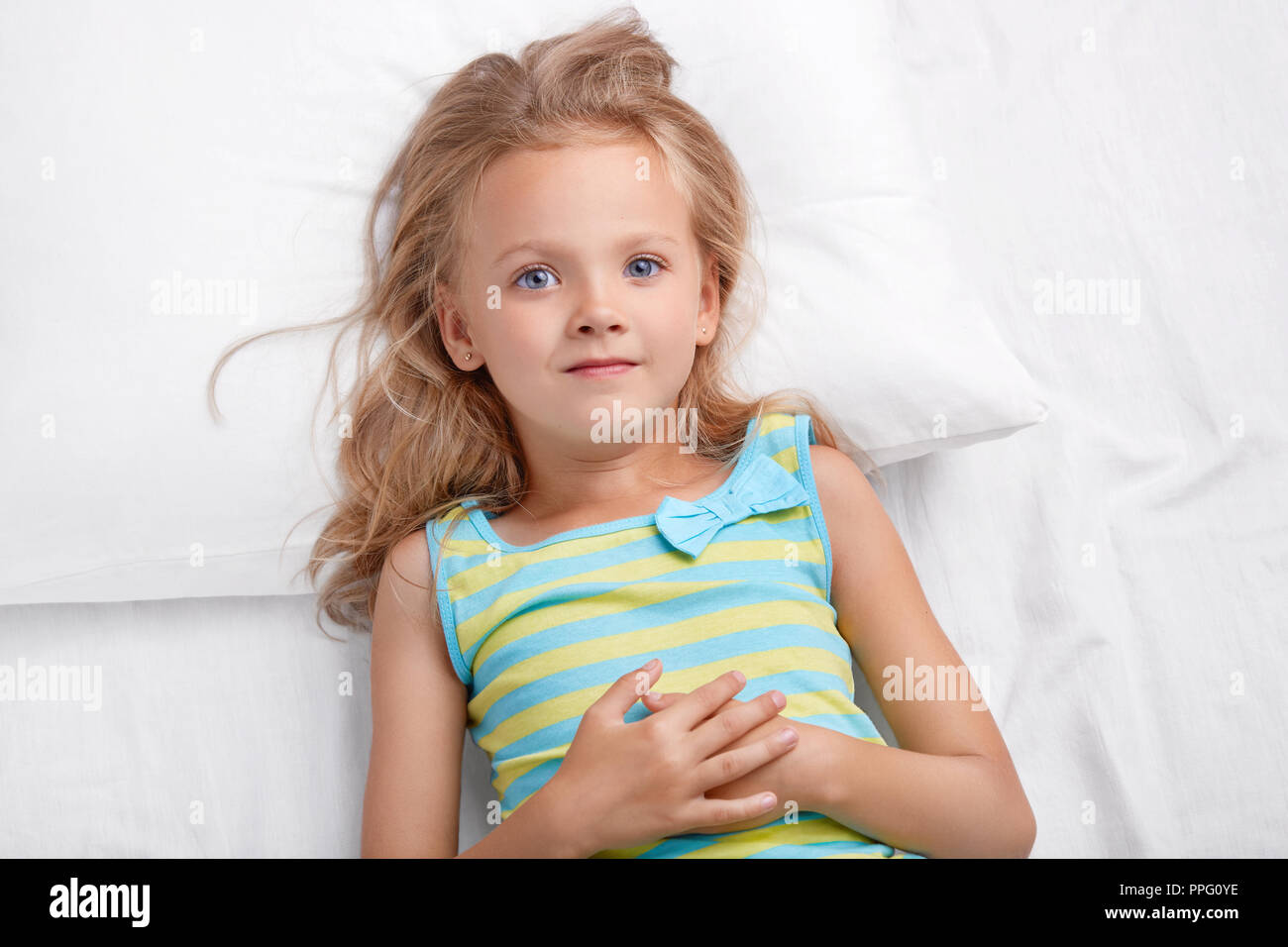 Good looking small kid with pleasant appearance, blue appealing eyes ...