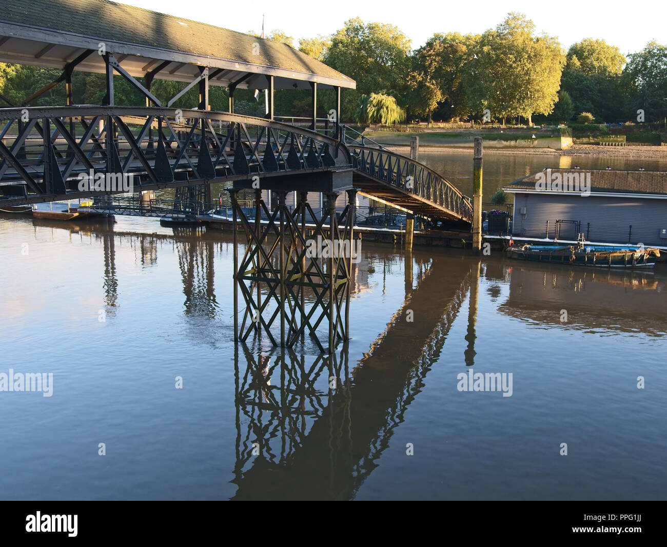 River Thames and old rusty steel bridge (pier). Beautiful reflection on ...