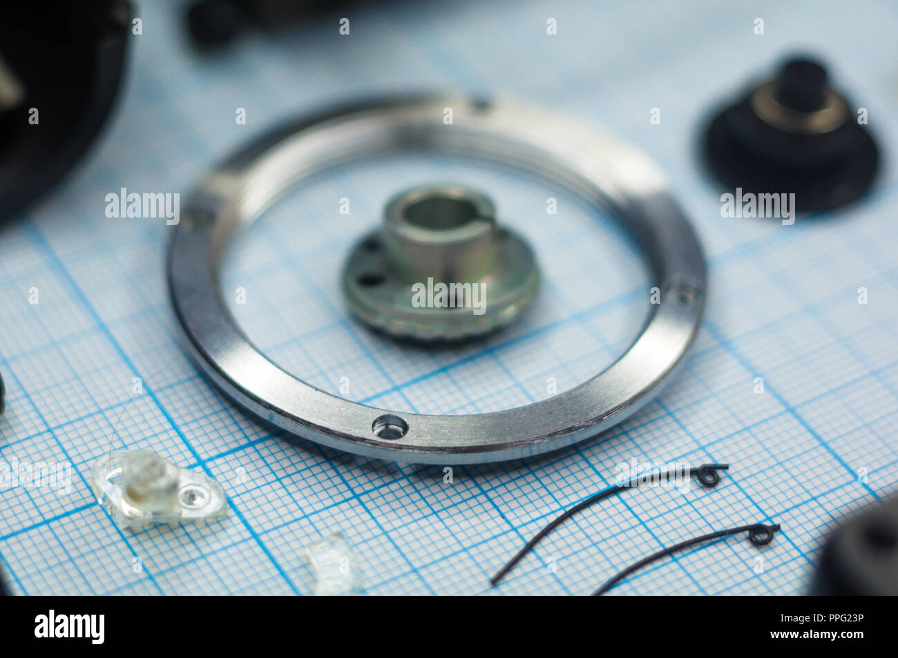 parts are completely disassembled old retro film SLR camera on graph ...