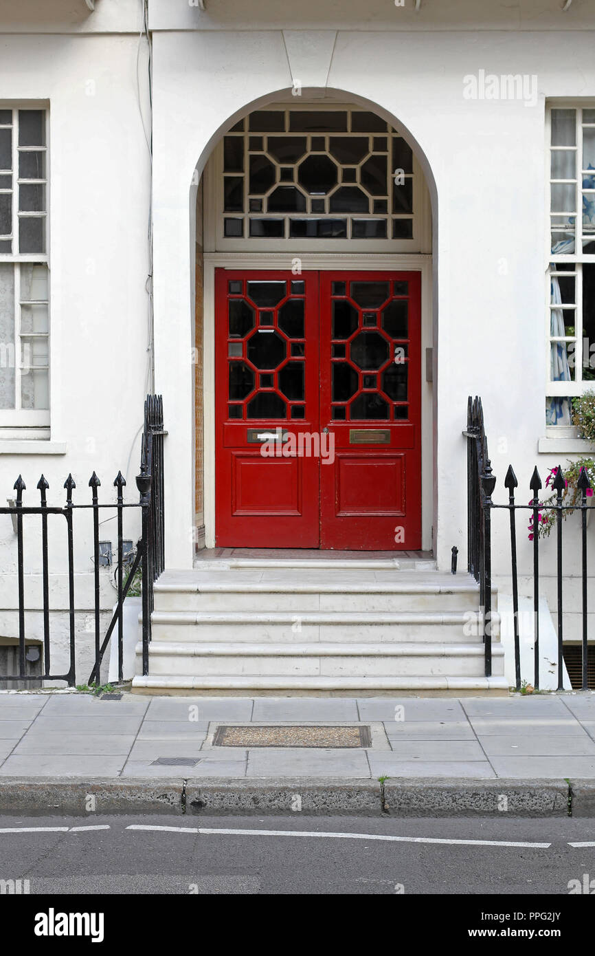 Retro dorway with red double entrance door Stock Photo - Alamy
