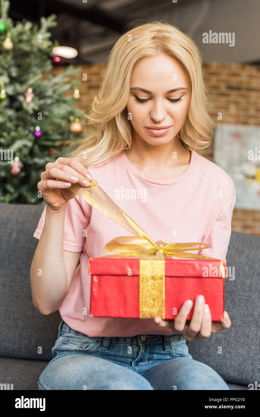 Beautiful young woman opening gift hi-res stock photography and images ...