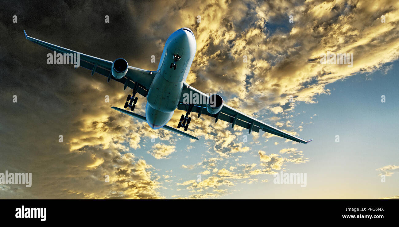 Passenger jet airliner flying overhead closeup with a yellow coloured ...