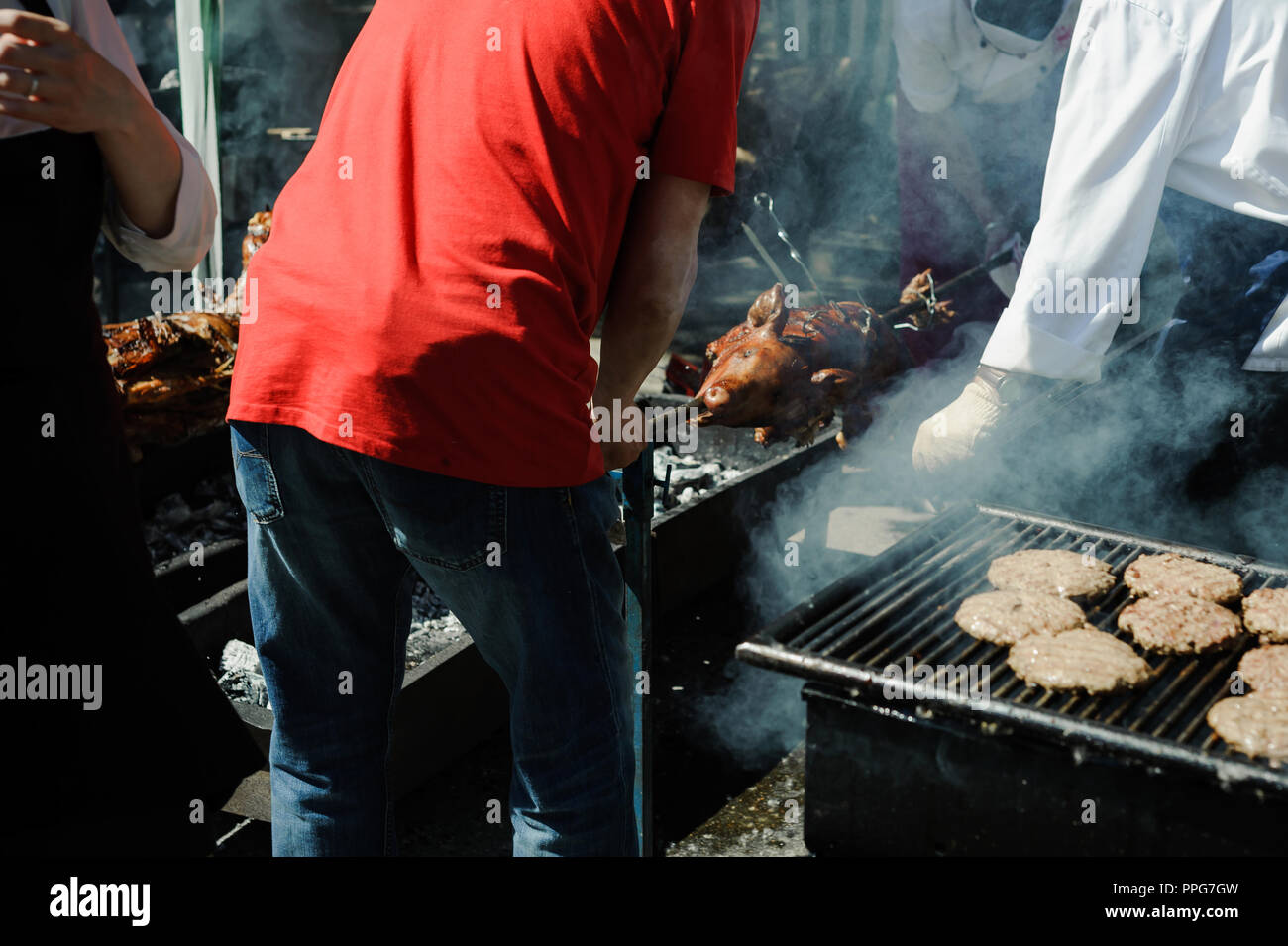cooks fry meat, carcass pig, outdoor Stock Photo - Alamy