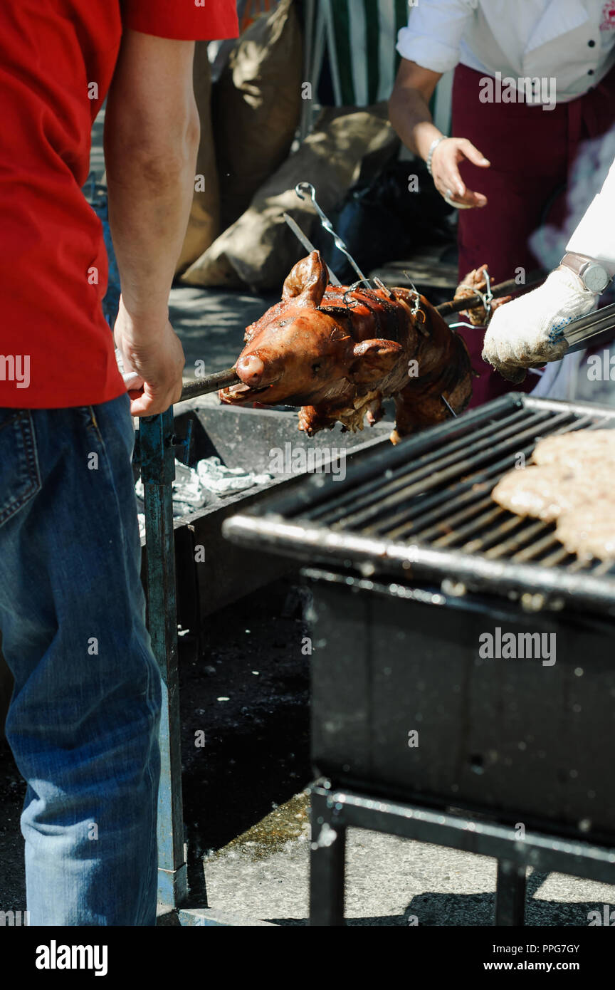 cooks fry meat, carcass pig, outdoor Stock Photo - Alamy