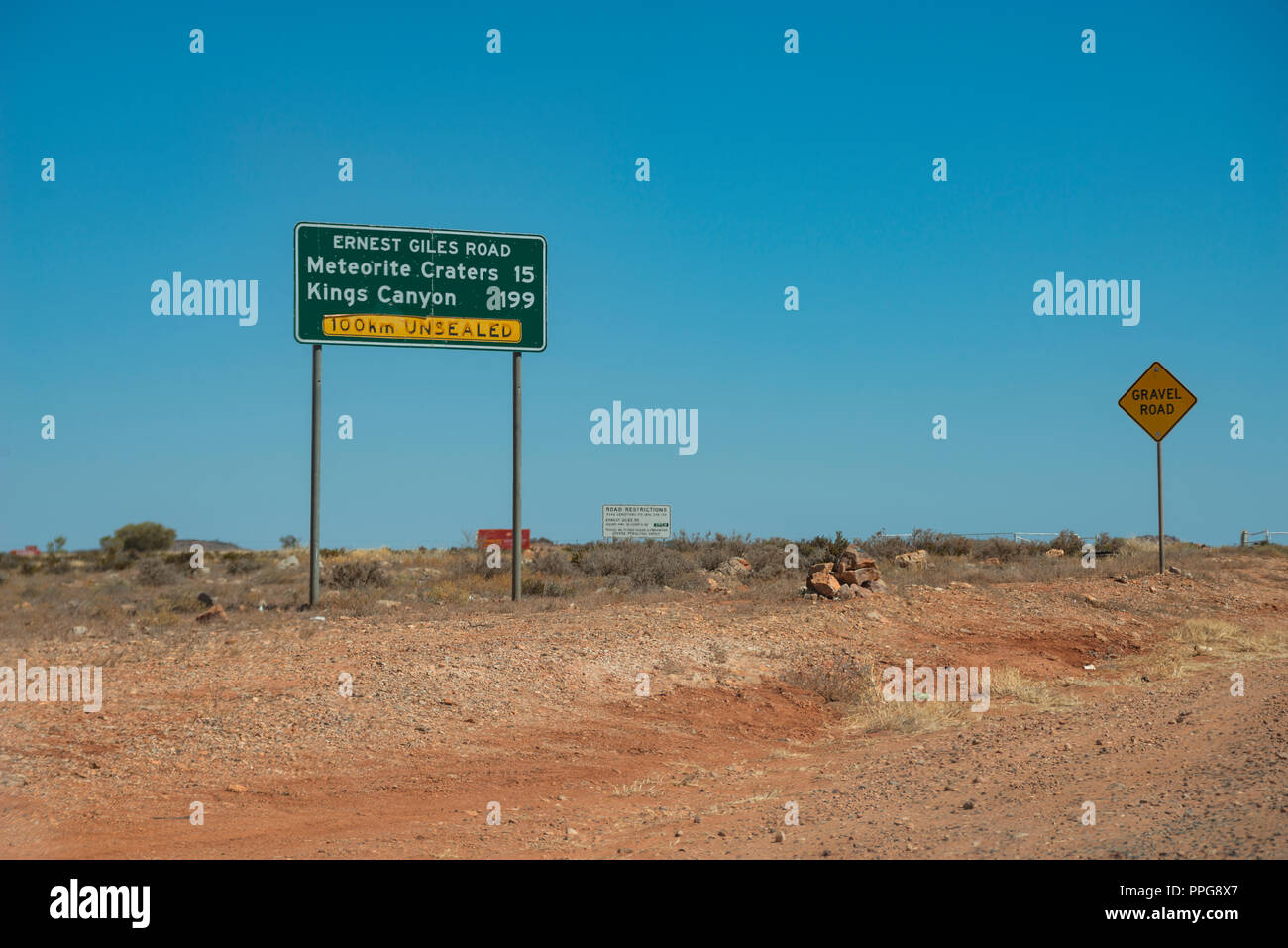 Road sign, 100km Unseald Gravel Road, Meteorite Crates, Ernest Giles ...