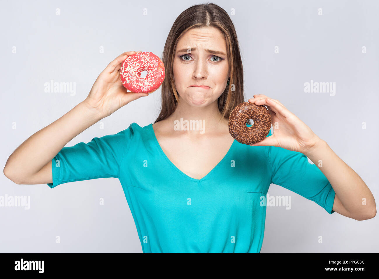 Portrait of upset in bad mood young beautiful girl in blue blouse ...
