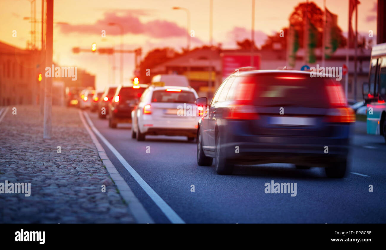 Cars moving on the road in city in late evening Stock Photo - Alamy