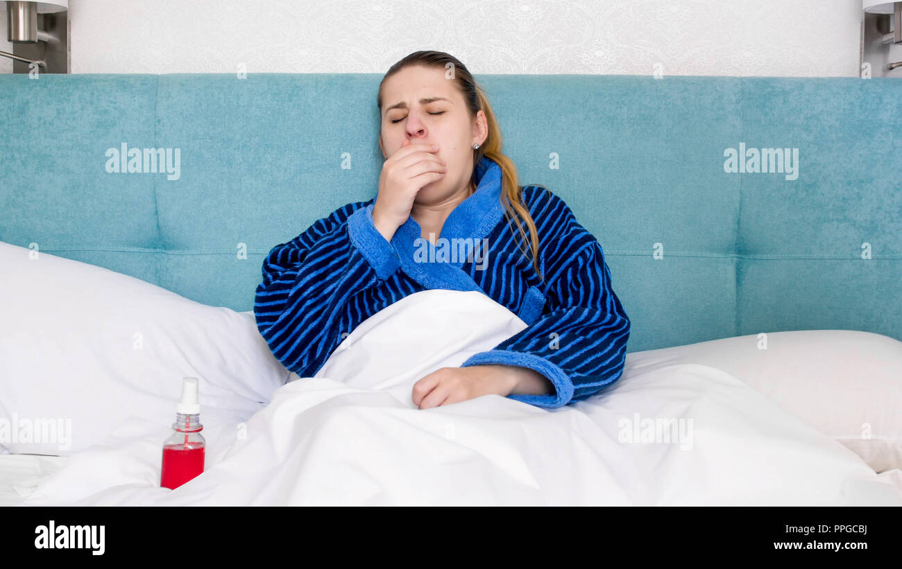 Portrait of woman caught virus and fever coughing in bed at home Stock ...
