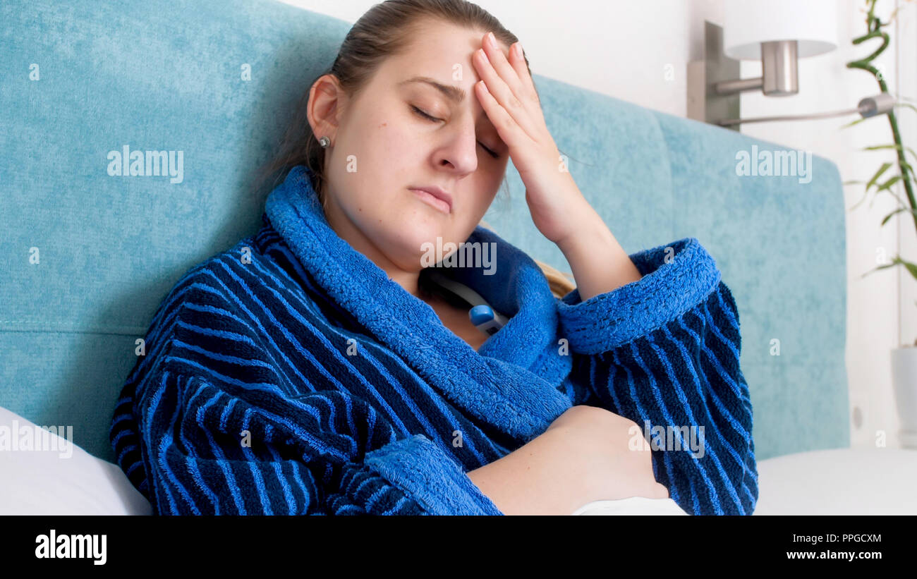 Closeup portrait of sick woman with flue measuring temperature and ...