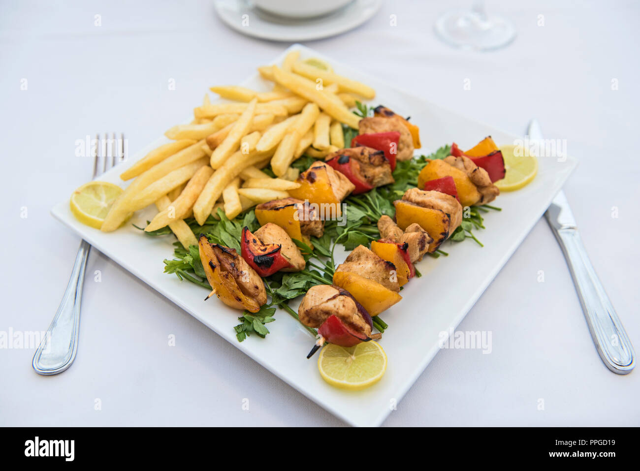Closeup of chicken shish tawook kebab meal on plate in outdoor luxury ...