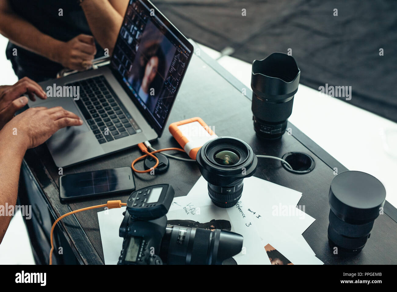 Photographer looking at photos after a photo shoot on a laptop ...