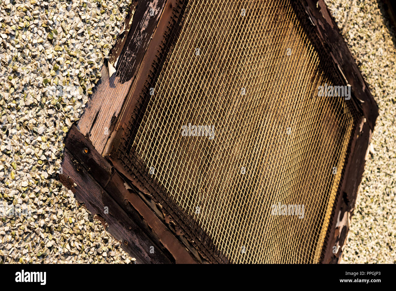 Old rocky wall with chain grated window hole Stock Photo - Alamy