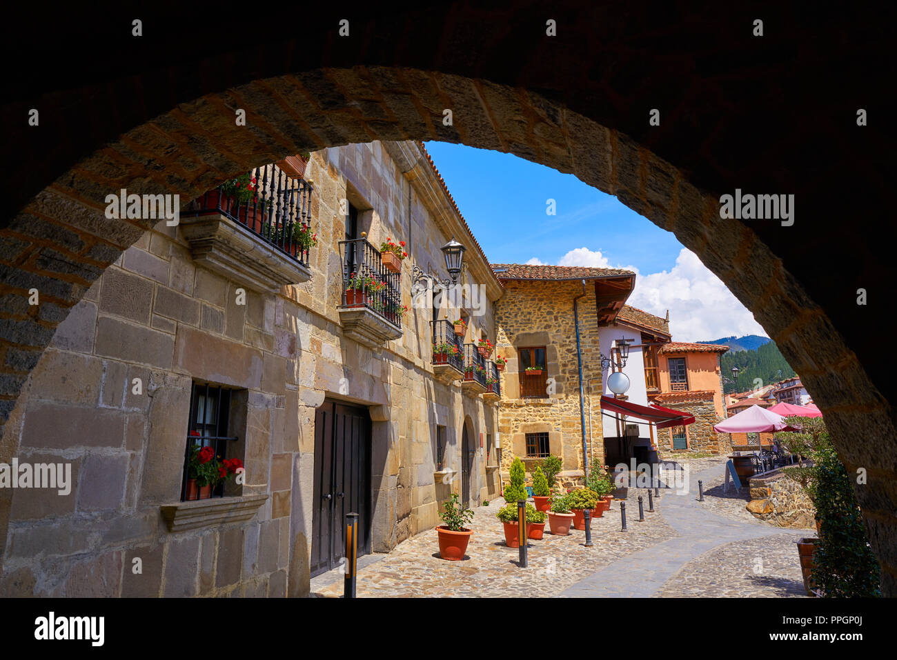 Potes village arch arcades in Cantabria of Spain Stock Photo - Alamy