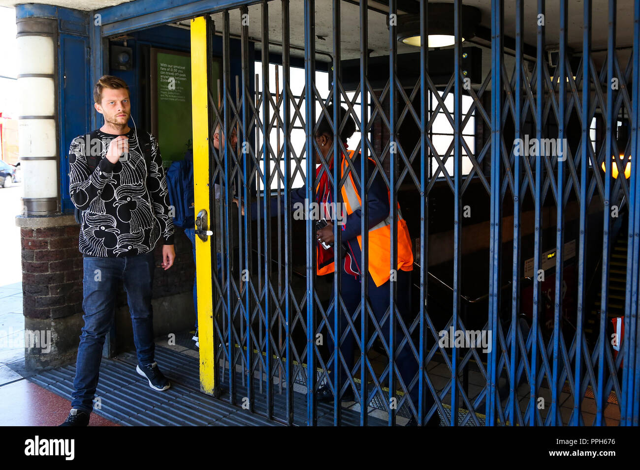 Turnpike Lane Station, North London. Uk 26 Sept 2018 - A staff member ...
