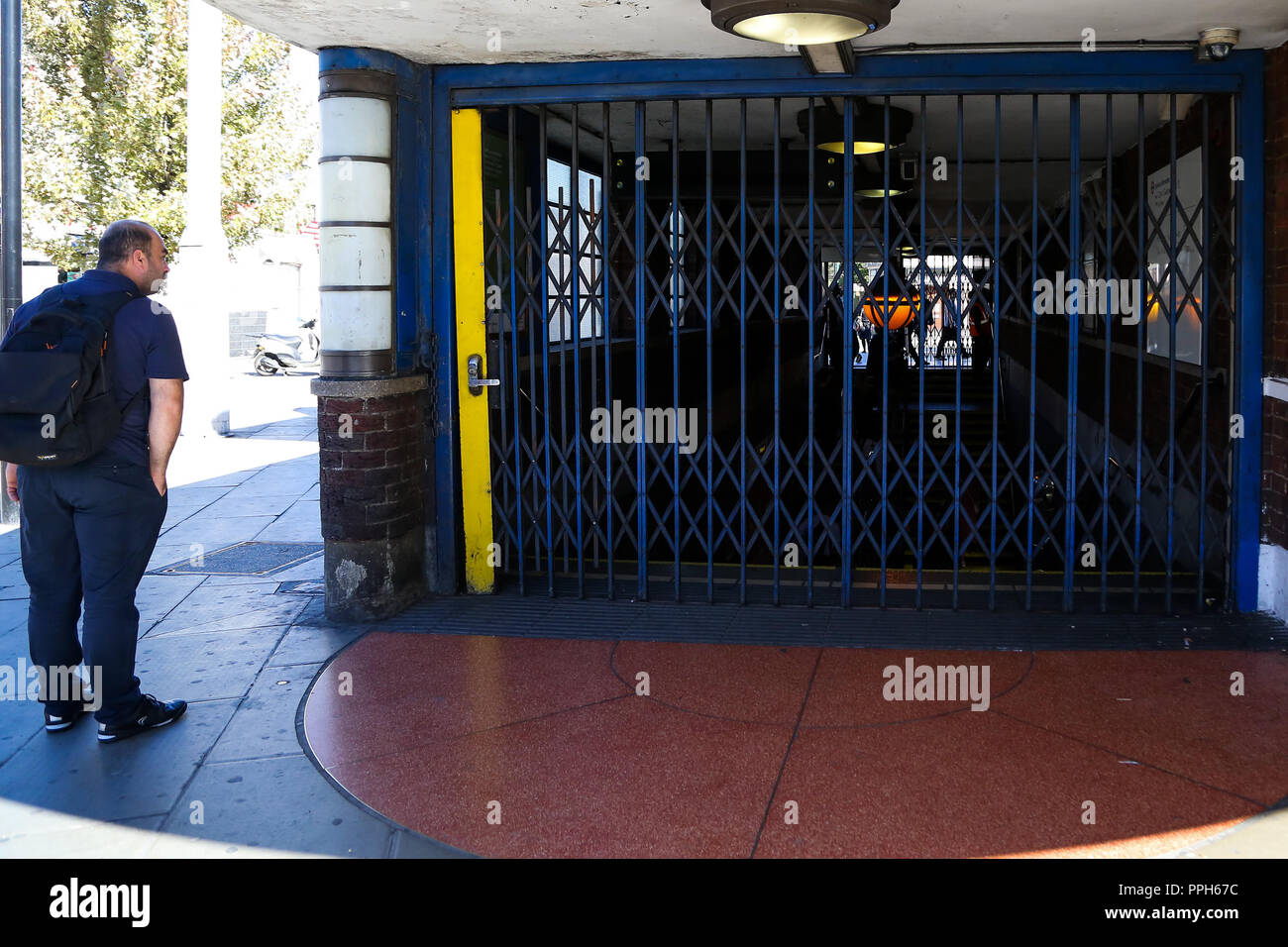 Turnpike Lane Station, North London. Uk 26 Sept 2018 - A commuter looks ...