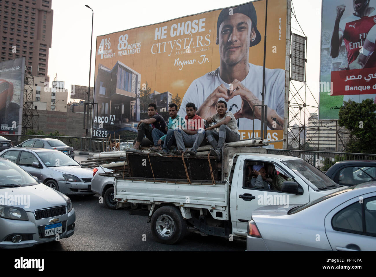 20 September 2018, Egypt, Cairo: Egyptian men ride on a truck passing ...