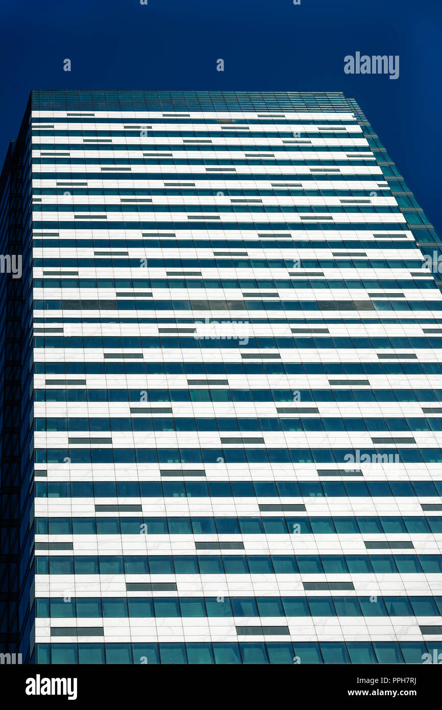 Front view of modern glass and concrete exterior of high rise building ...