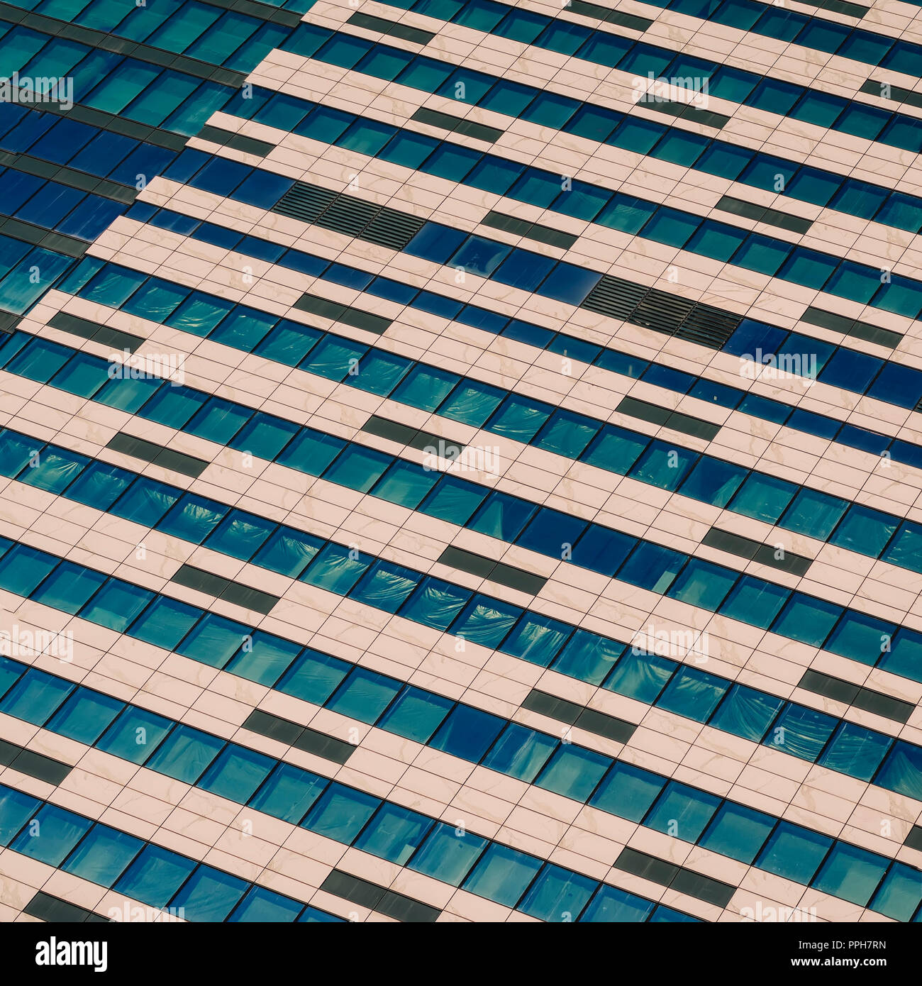 Windows of under construction high-rise building. Front view of modern ...