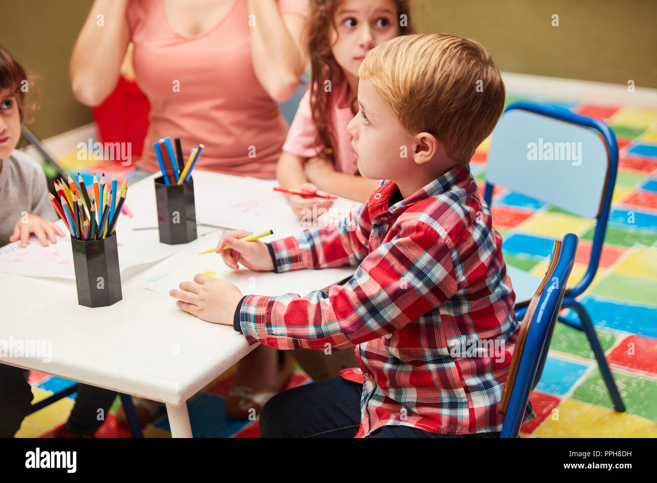 Group of kids in the drawing class in kindergarten or preschool are ...