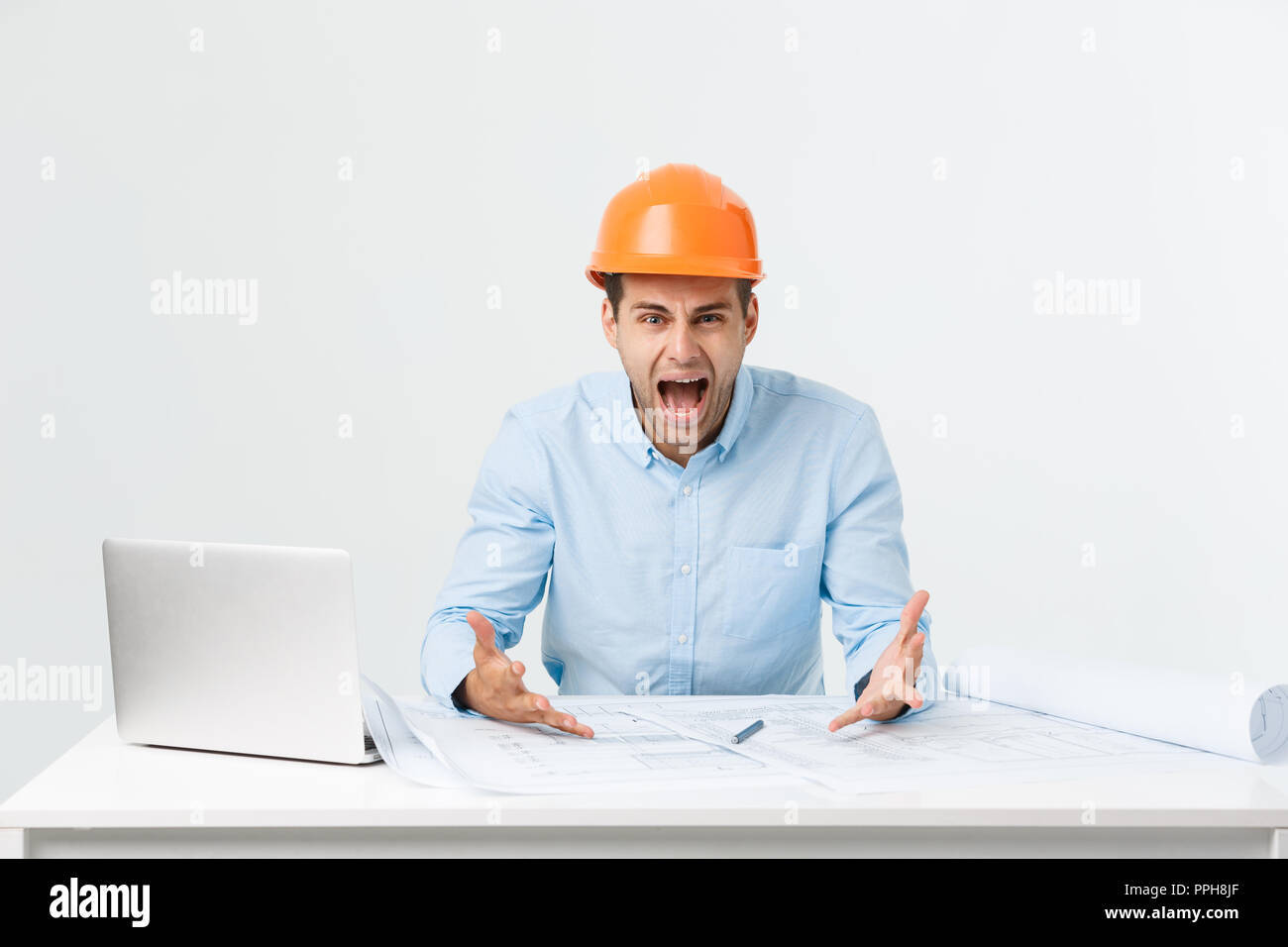 Young Engineer angry during working with laptop in office building site ...