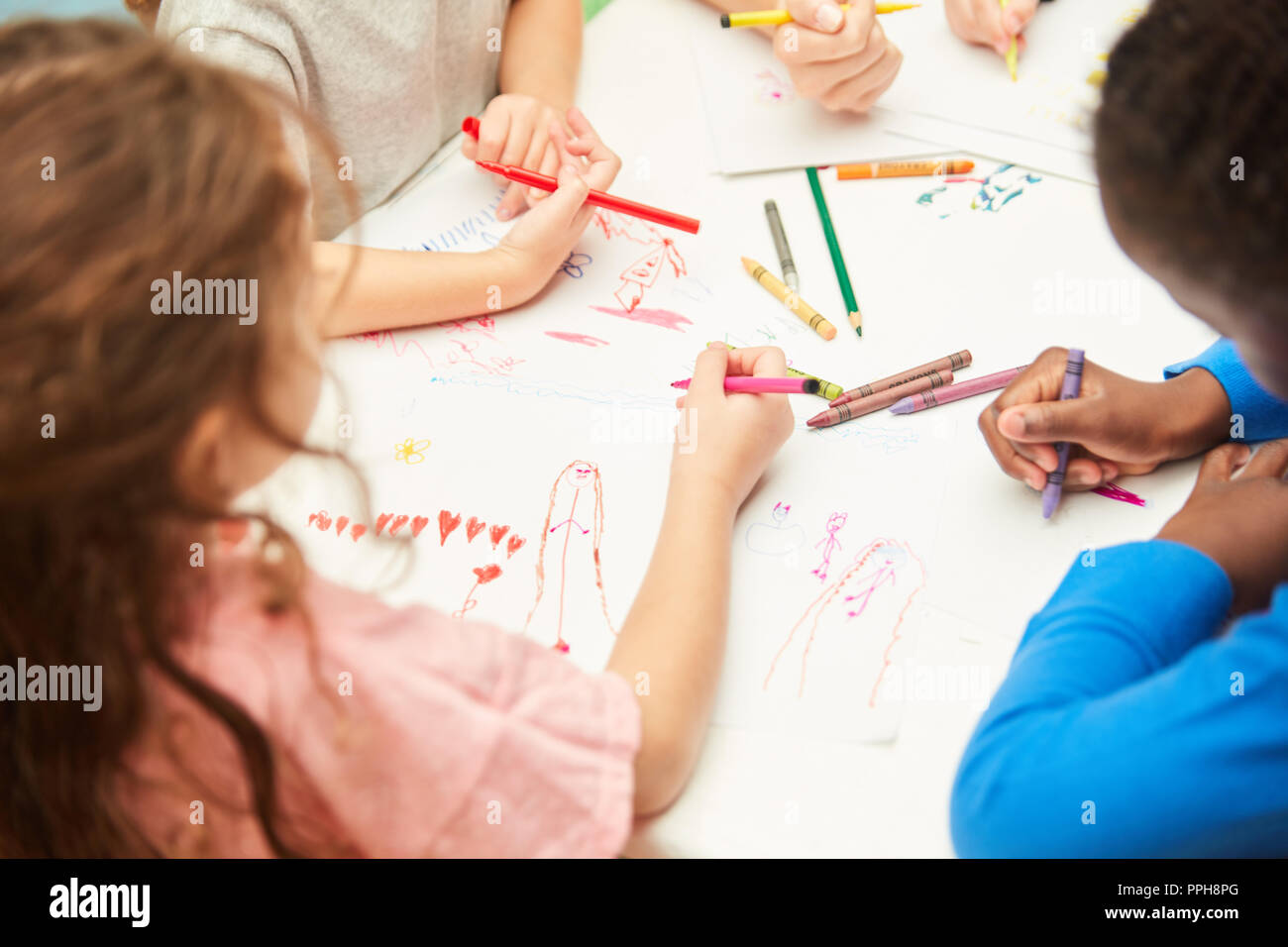 Children paint fantasy pictures with felt-tip pens in creative drawing ...