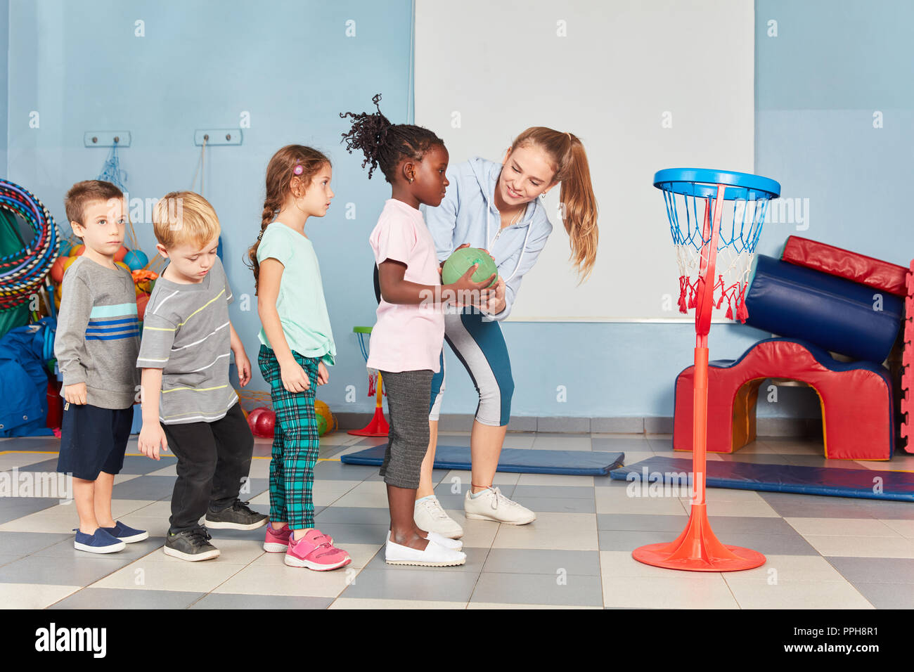 Group of kids as a student team during basketball training in the ...